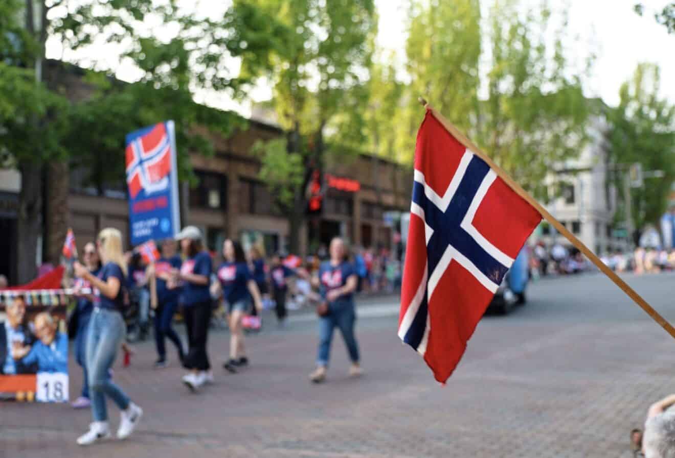Norwegian flags wave at Syttende Mai parade - My Ballard