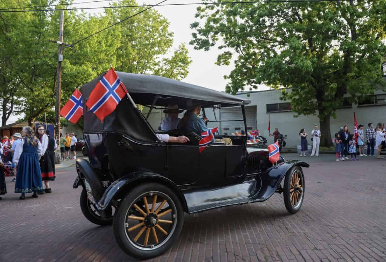 Norwegian flags wave at Syttende Mai parade - My Ballard